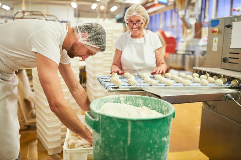 Baker Team with Apprentice on the Conveyor Belt Baking the Rolls Stock ...