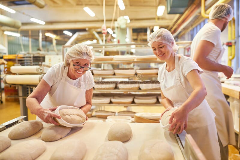 Baker Team with Boss and Apprentices Baking Bread Stock Photo - Image ...