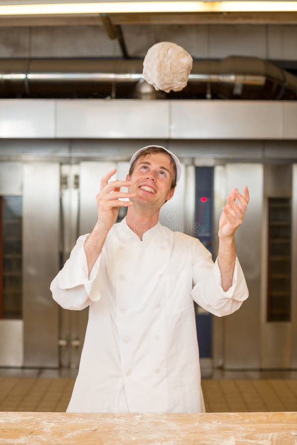 Baker Throwing Dough into Air in Bakehouse Stock Image - Image of work ...