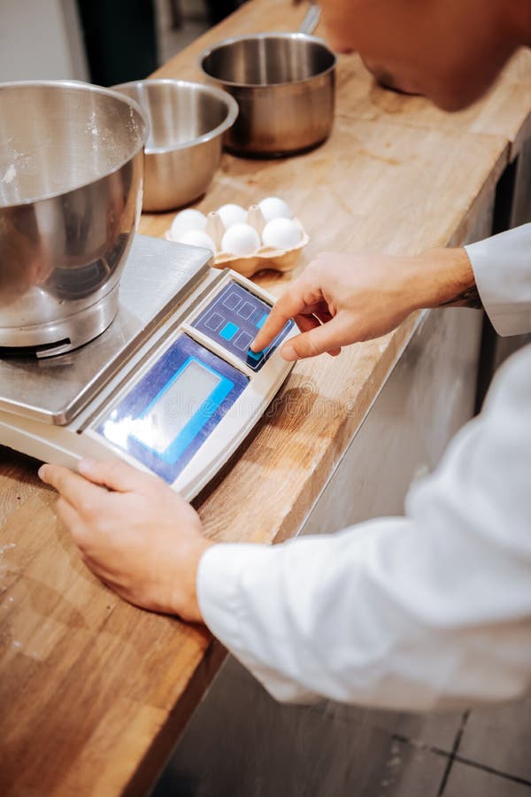 Baker Using Kitchen Scale while Weighing Whipped Whites Stock Photo ...