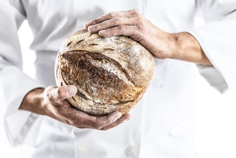 A Baker in White Work Clothes is Holding a Fresh Loaf of Bread Stock ...
