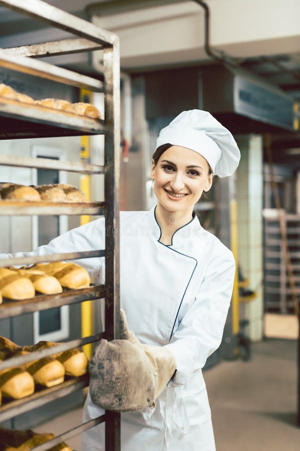 Baker Woman Pushing Sheets with Bread in the Baking Oven Stock Image ...