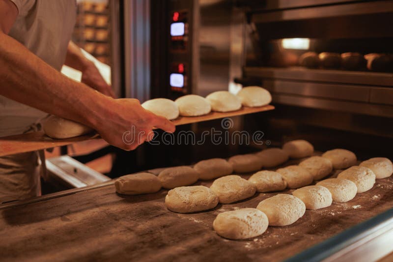 Baker Working in the Kitchen, Preparing Loaves of Bread Stock Image ...