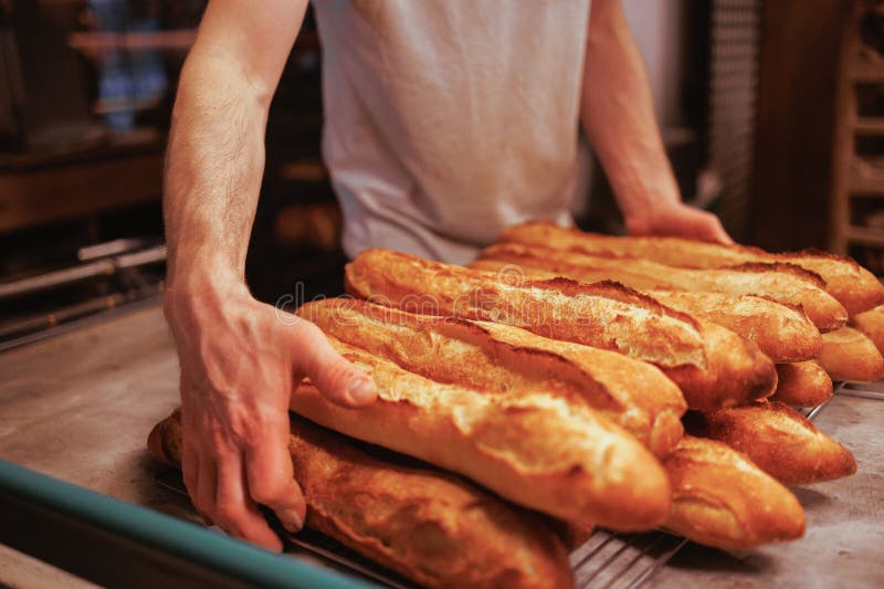 Baker Working in the Kitchen, Preparing Loaves of Bread Stock Photo ...