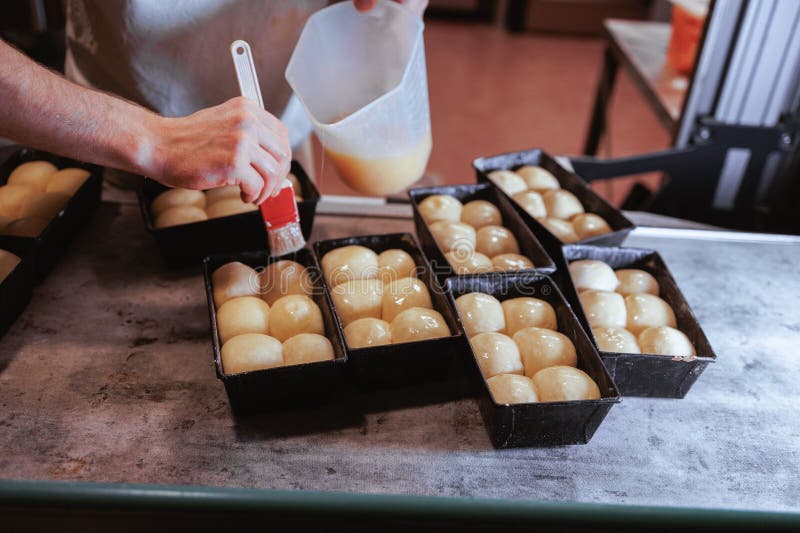 Baker Working in the Kitchen, Preparing Loaves of Bread Stock Photo ...
