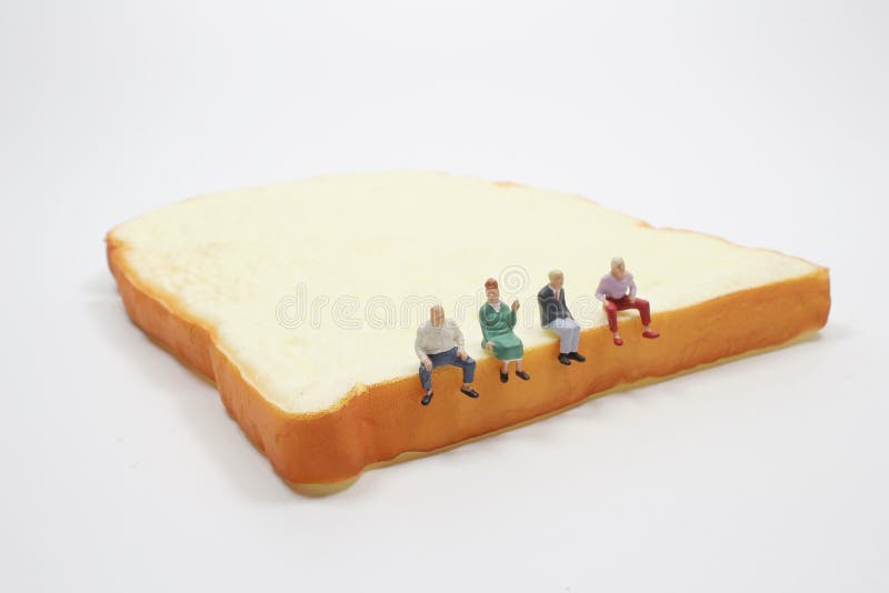 A Bakers and Bread Concept. Miniature Baker Figures Sitting on a Slice ...