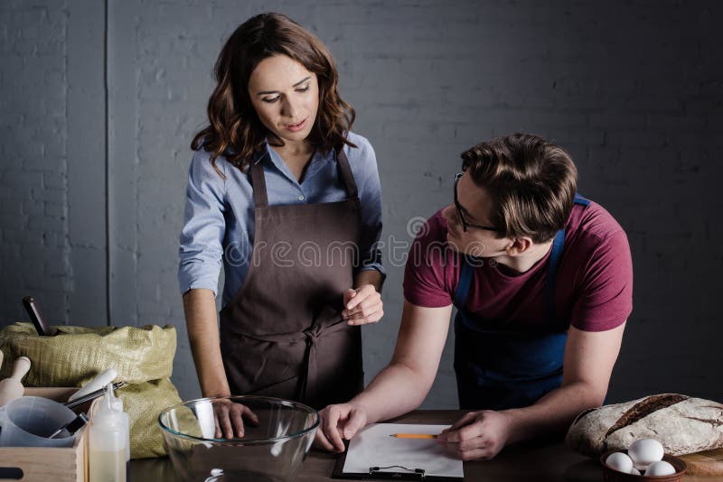 Bakers Discussing Ingredients Stock Photo - Image of business ...