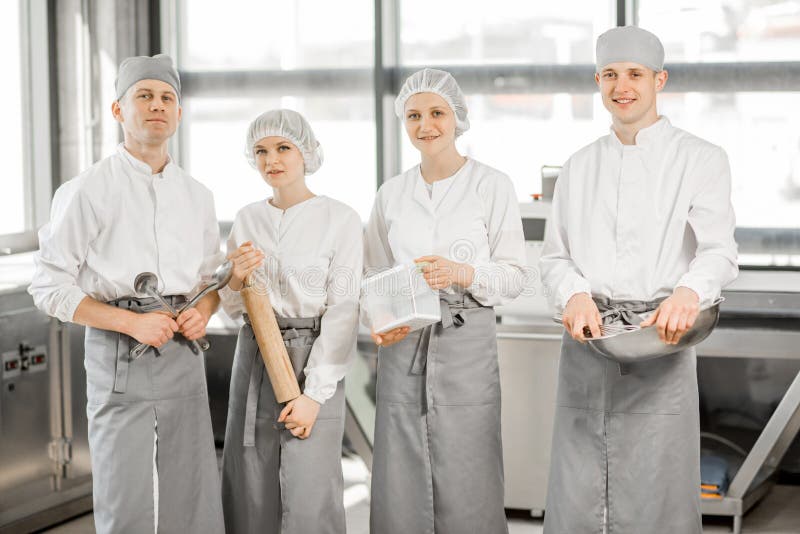A Group of Bakers Smiles at the Bakery Stock Photo - Image of staff ...