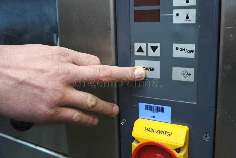 At the Bakery: Baker Hand Pressing Power Button on a Control Panel of ...