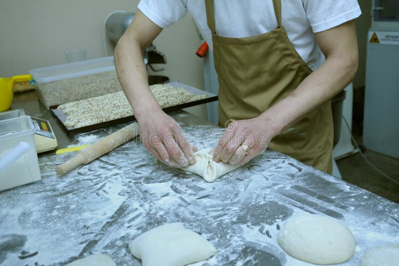 At the Bakery: Baker Hands Forming Dough for Baking Bread Standing at ...
