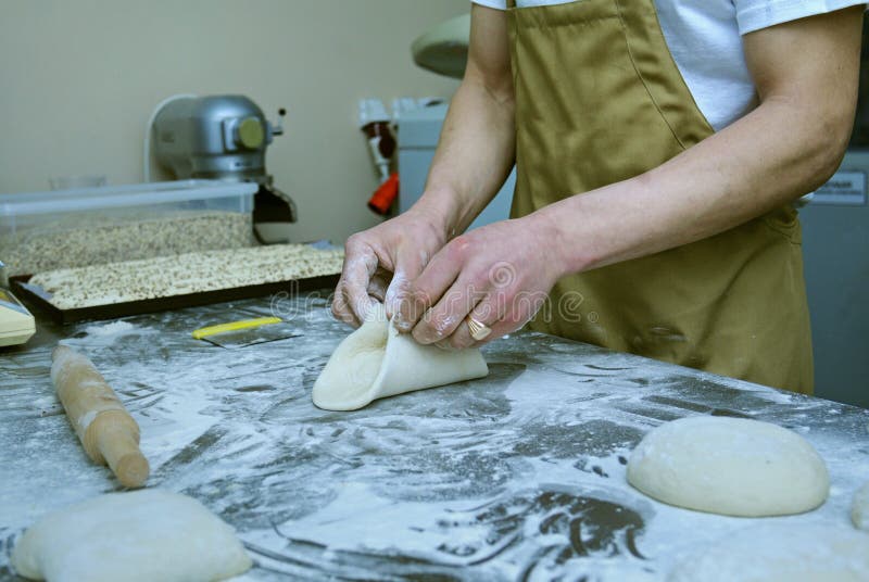 At the Bakery: Baker Hands Forming Dough for Baking Bread Standing at ...