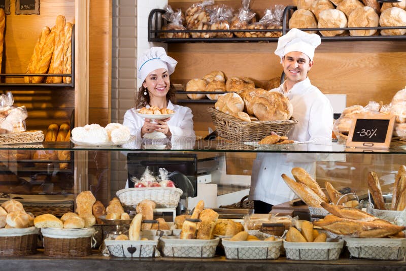 Bakery Staff Offering Bread and Different Pastry Stock Photo - Image of ...