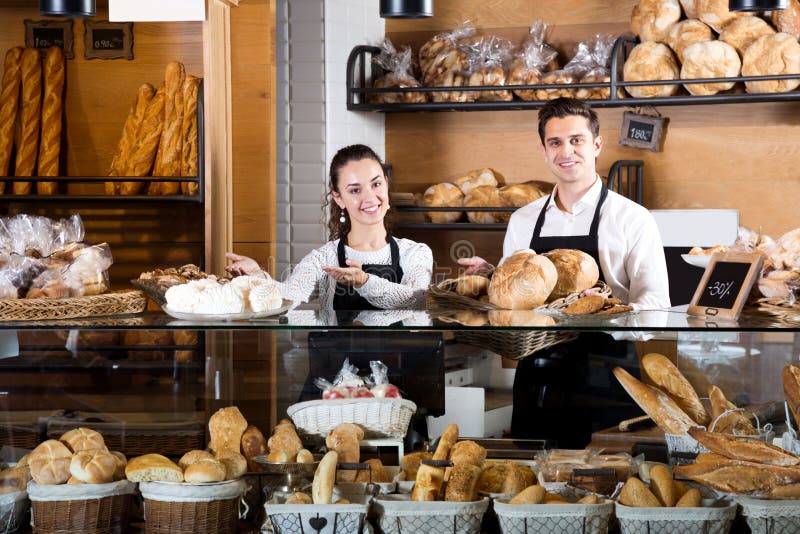 Bakery Staff Offering Bread and Different Pastry Stock Photo - Image of ...