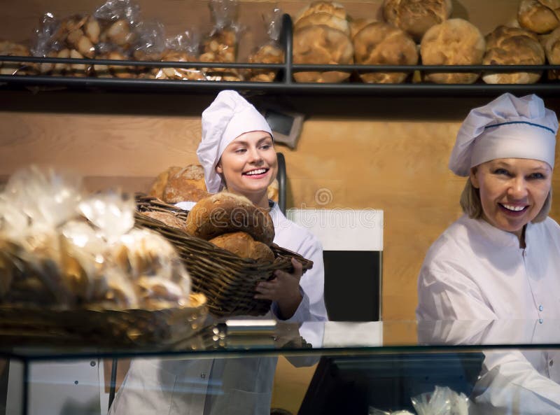 Bakery Staff Offering Bread and Different Pastry for Sale Stock Photo ...