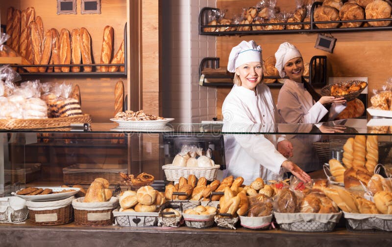 Bakery Staff Offering Bread Stock Photo - Image of loaf, cookies: 79995440