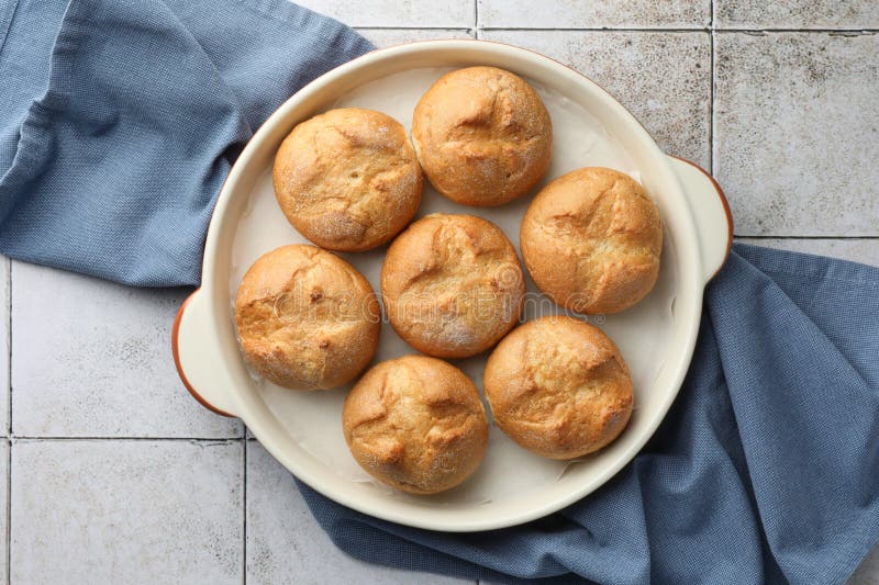 Baking Dish with Homemade Tasty Buns on Textured Tiled Table, Top View ...