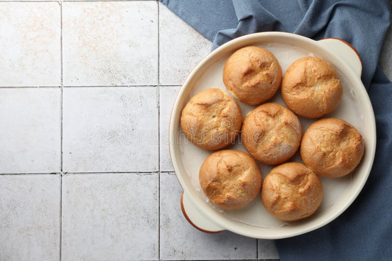 Baking Dish with Homemade Tasty Buns on Textured Tiled Table, Top View ...