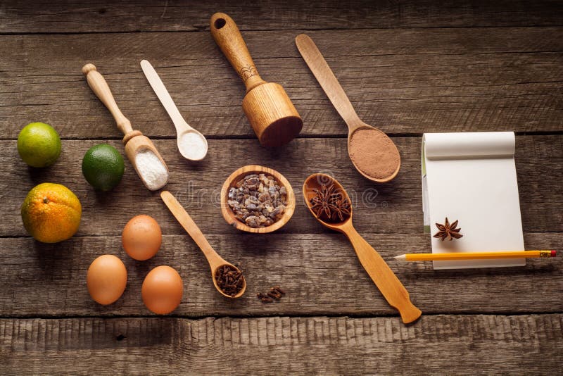 Baking Ingredients on Rustic Table with Notebook. Eggs, Flour, Brown ...