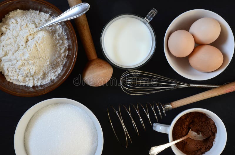 Baking Ingredients on a Dark, Stone Table: Eggs, Flour and Milk Stock ...