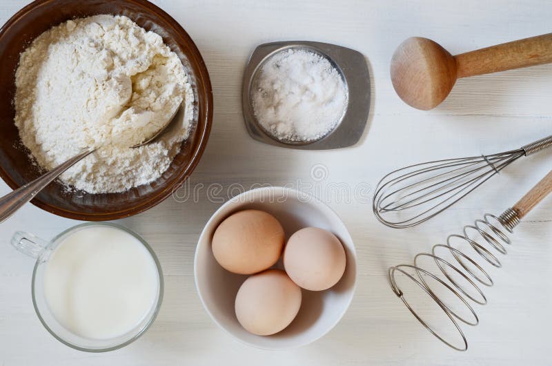 Baking Ingredients on a Dark, Stone Table: Eggs, Flour and Milk Stock ...
