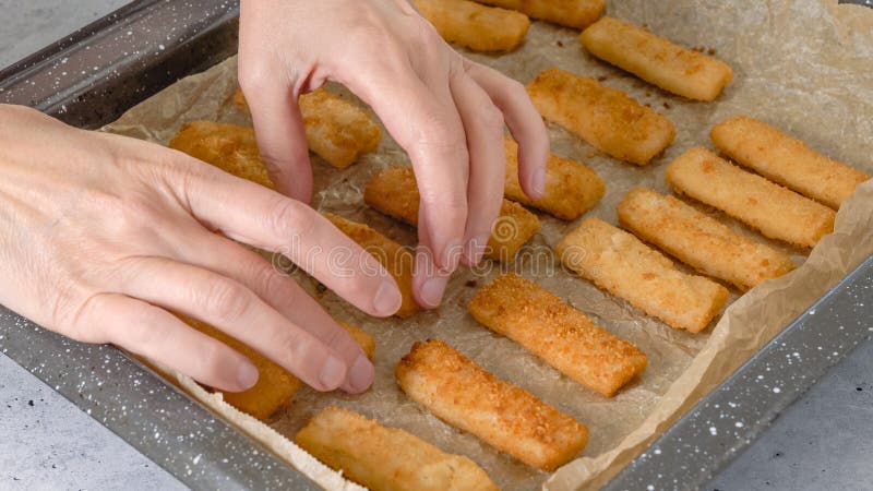 Baking Pan with Fish Sticks Close Up on the Kitchen Table. Crunchy ...