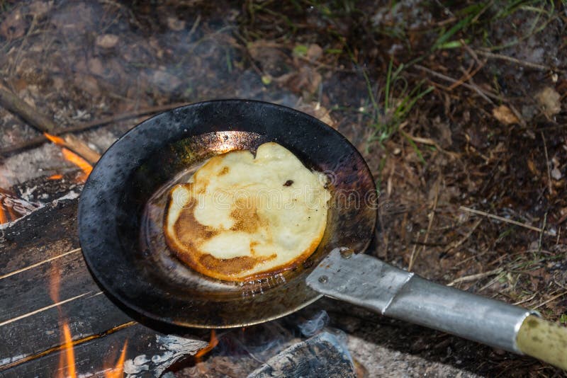 Baking pancakes on a fire. stock image. Image of food - 68376335