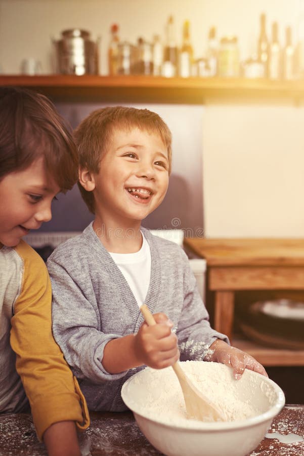 Baking with a Smile. Two Young Brothers Baking in the Kitchen. Stock ...