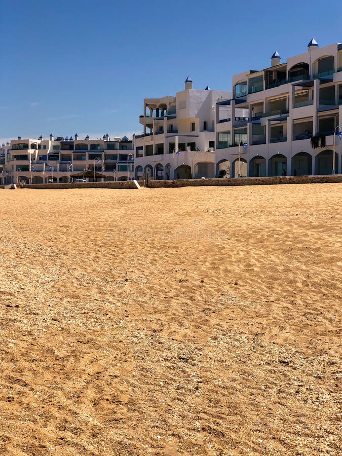 Balanced Beachscape a Harmonious Blend of Sand, Buildings, and Natural ...