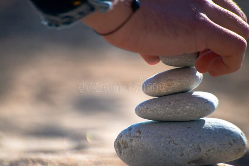 Balanced Completion Placing the Last Stone by the Seaside Stock Photo ...