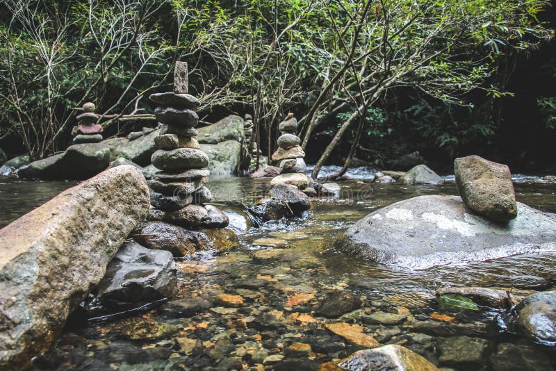 Balanced Stone Pyramide on Shore of Water Fall of Mountain Lake. Blue ...