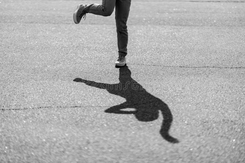 A Person Playfully Balancing on One Foot, Casting a Unique Shadow ...