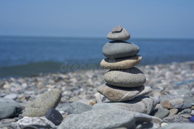 Balancing Rocks on a Pebble Beach during Sunset. Smooth Pebbles on the ...