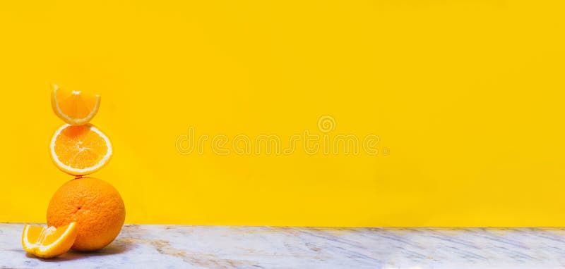 Balancing Stack of Fresh Sliced Oranges. Yellow Background. Summer ...