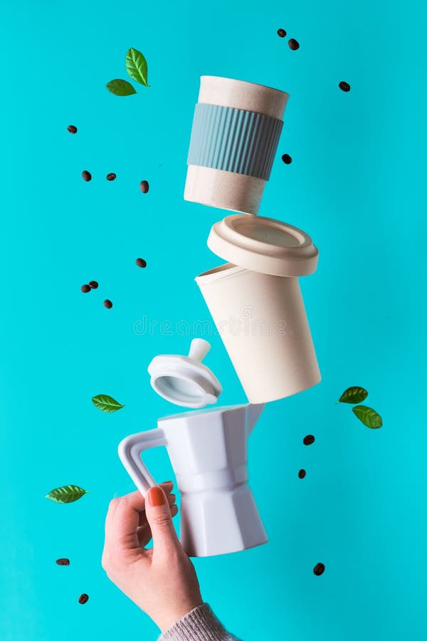 Balancing Zero Waste Coffee Pyramid in Female Hands on Blue Mint ...