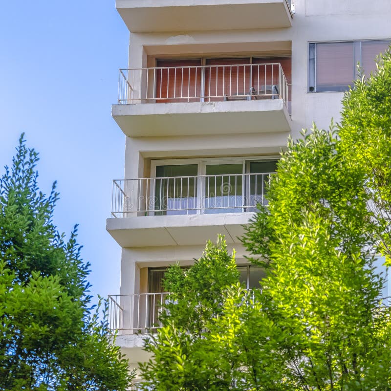 Balconies of a Building with Trees in Front Stock Photo - Image of ...