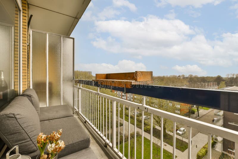 A Balcony with a Couch and a View of a Stock Image - Image of railing ...