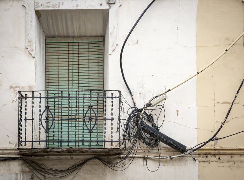 Balcony and a Mess of Electrical Wires Outside of a Building Stock ...