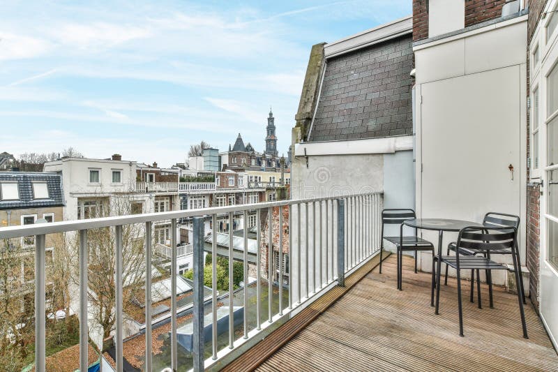 A Balcony with a Table and Chairs and a View Stock Image - Image of ...