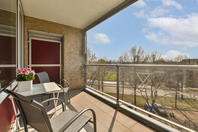 A Balcony with a Table and Chairs and a Window Stock Image - Image of ...