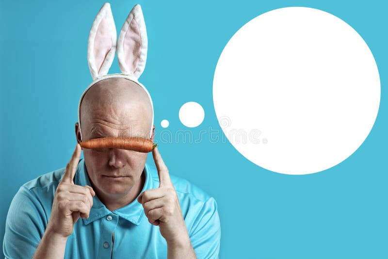 Bald Brutal Man in a Light Shirt and Bunny Ears. in the Hands of he ... Bald Brutal Man in a Light Shirt and Bunny Ears. in the Hands of he ...