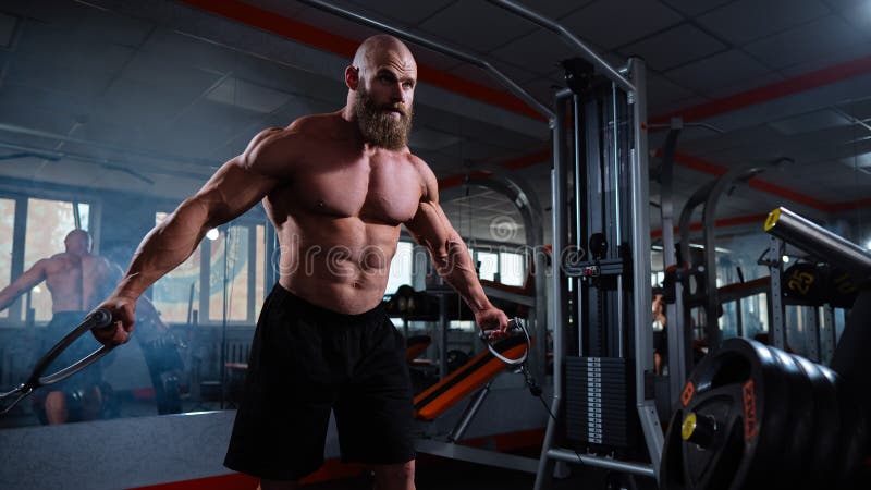 Bald Caucasian Bodybuilder Training Chest Using Cable Crossover in Gym ...