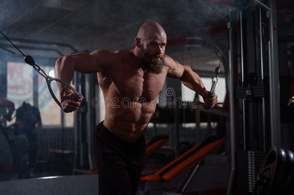 Bald Caucasian Bodybuilder Training Chest Using Cable Crossover in Gym ...
