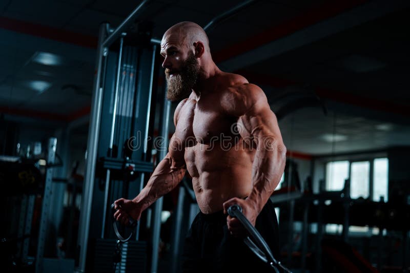 Bald Caucasian Bodybuilder Training Chest Using Cable Crossover in Gym ...