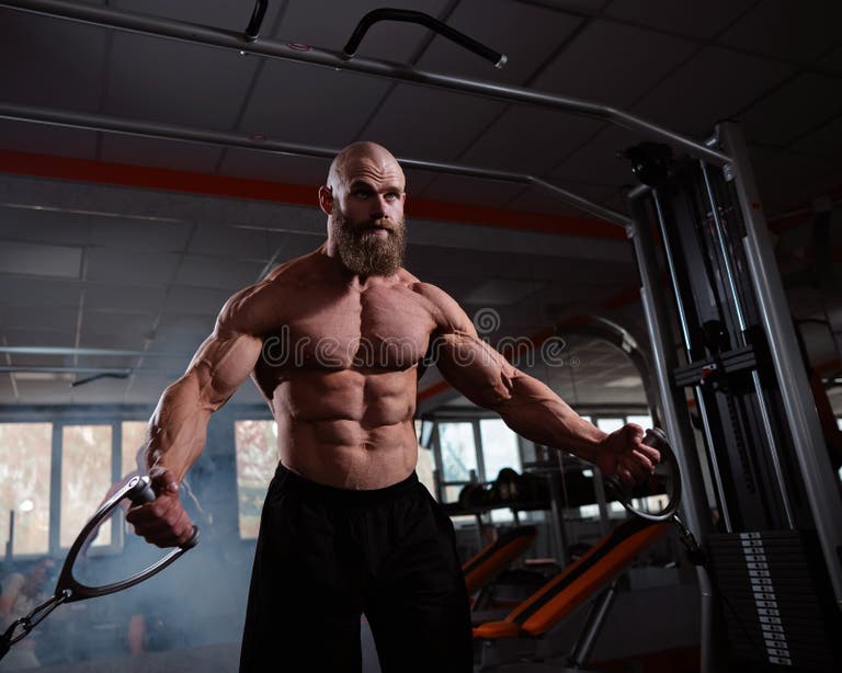 Bald Caucasian Bodybuilder Training Chest Using Cable Crossover in Gym ...