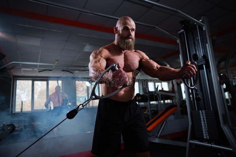 Bald Caucasian Bodybuilder Training Chest Using Cable Crossover in Gym ...