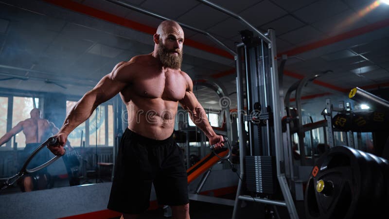 Bald Caucasian Bodybuilder Training Chest Using Cable Crossover in Gym ...