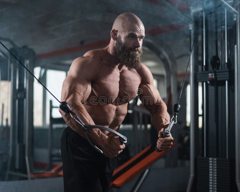Bald Caucasian Bodybuilder Training Chest Using Cable Crossover in Gym ...