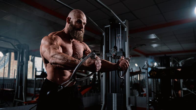 Bald Caucasian Bodybuilder Training Chest Using Cable Crossover in Gym ...