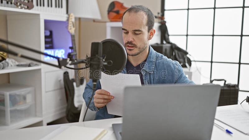 Bald Hispanic Man with Beard Recording in a Modern Studio Using ...