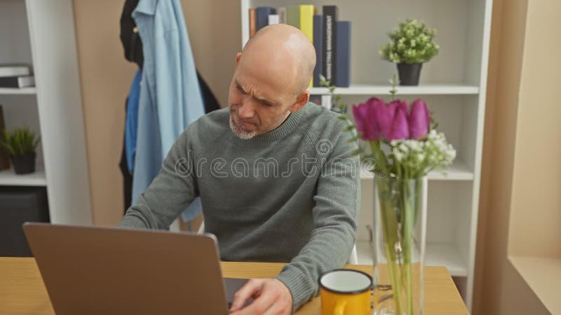 Bald Man with Beard Casually Dressed Using Laptop at a Wooden Table in ...